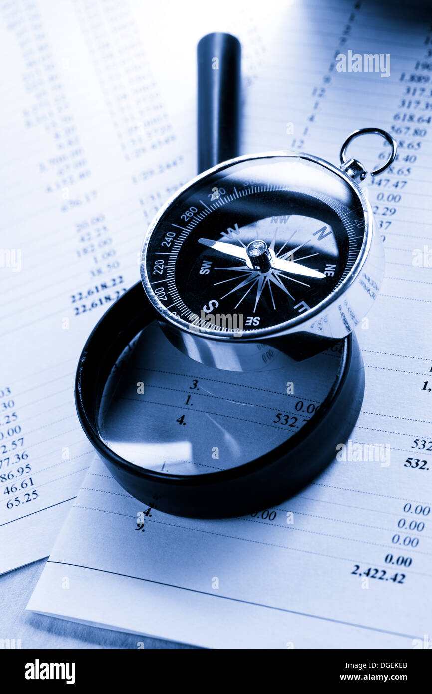 Operating budget, magnifying glass and black compass Stock Photo - Alamy