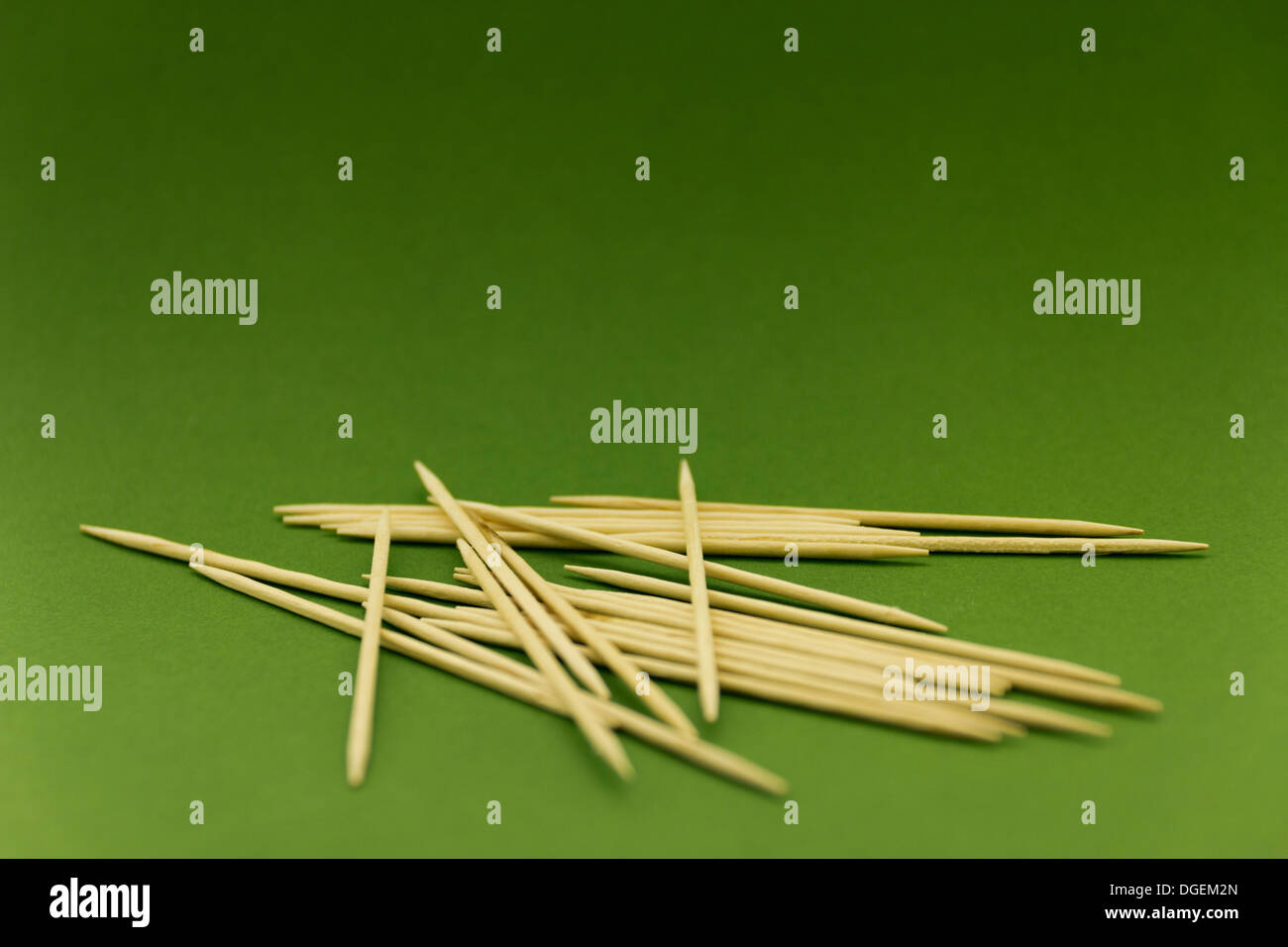 Toothpicks on a green background Stock Photo - Alamy
