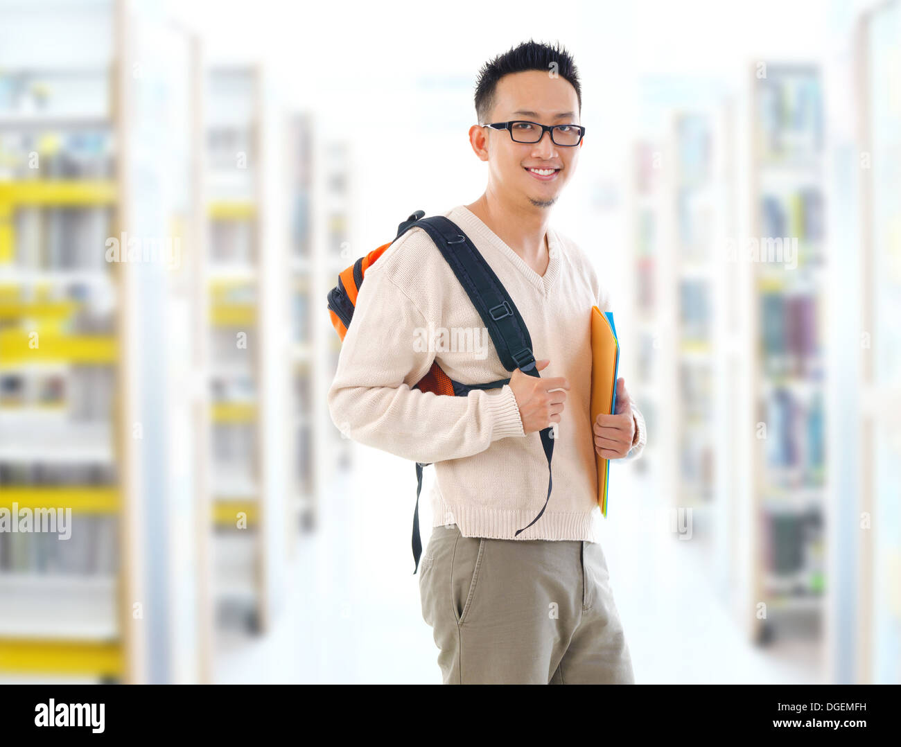 Southeast Asian adult student in casual wear with school bag carrying ...