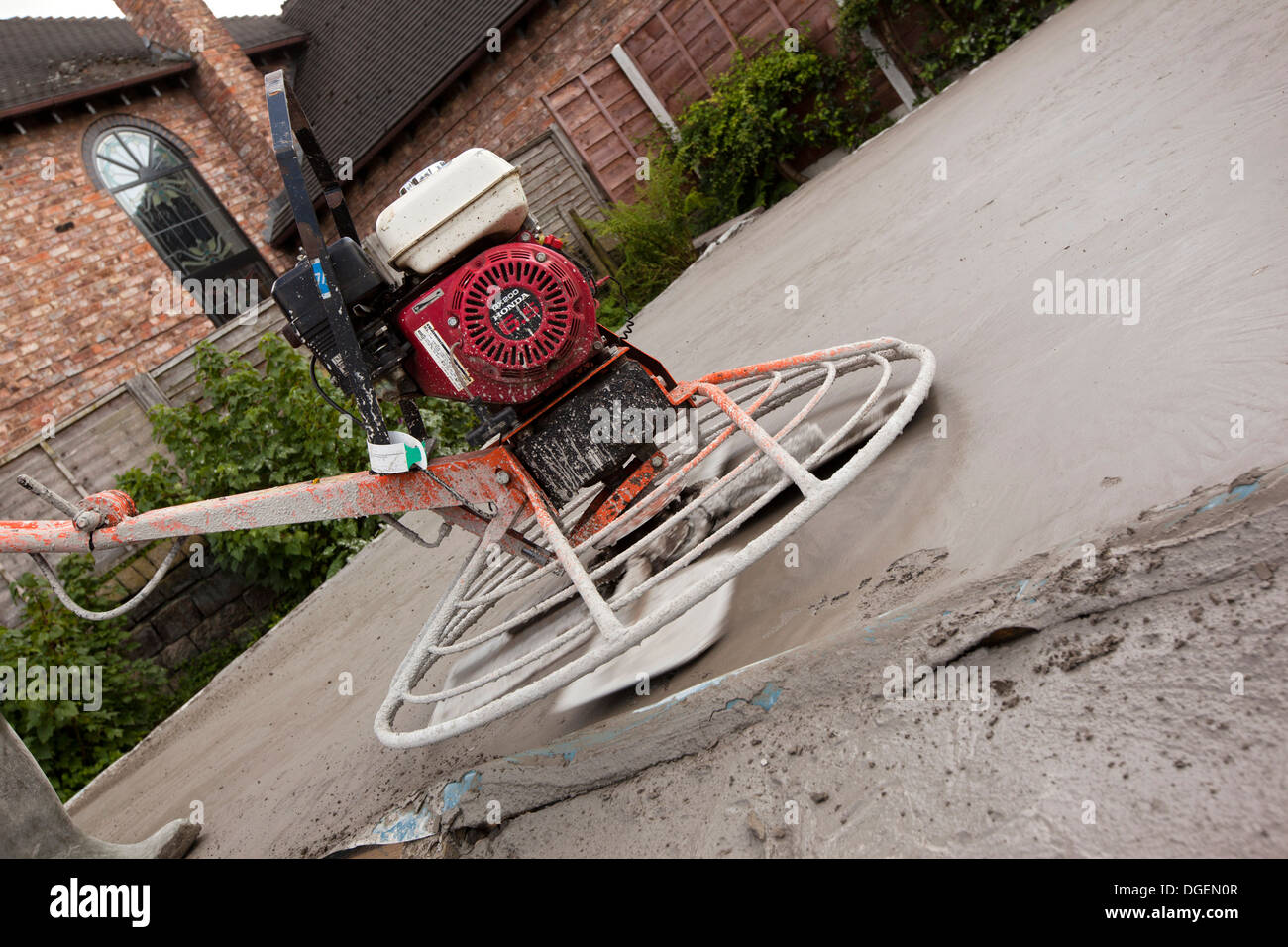 self building house, man using Honda power float mechanical trowel to ...
