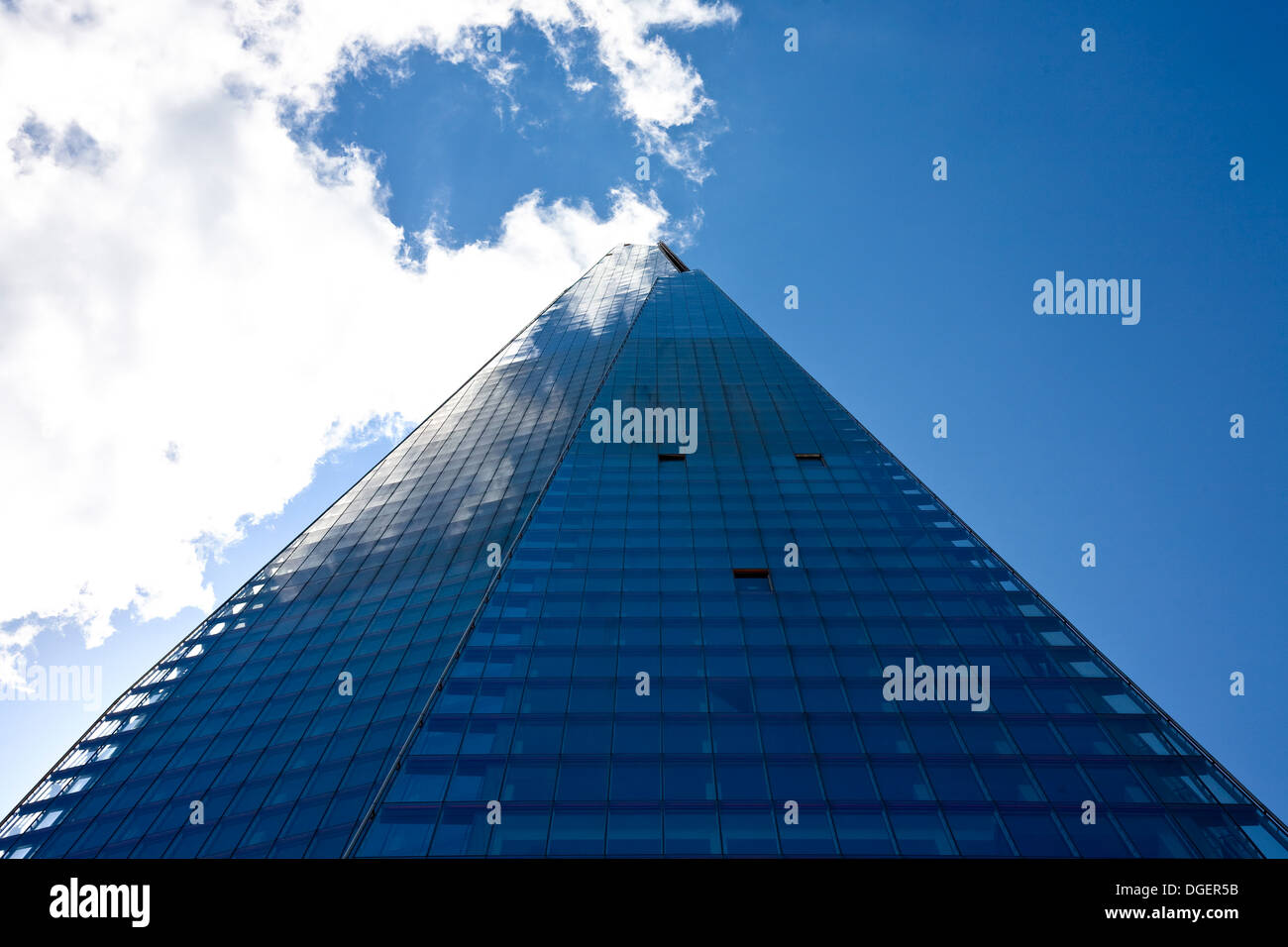 Looking upwards at glass windows on London's Shard Building's against a ...