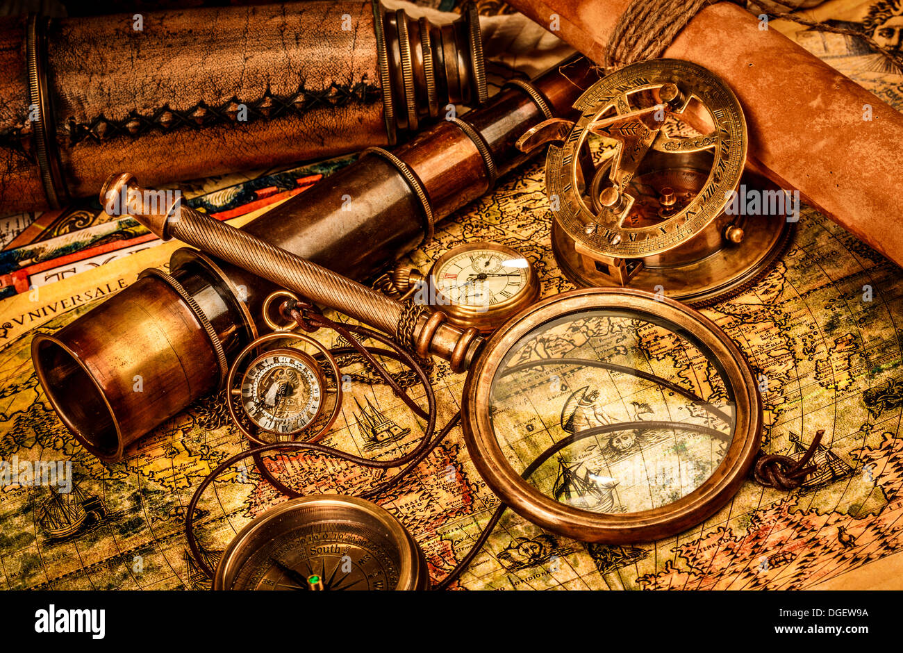 Vintage magnifying glass, compass, telescope and a pocket watch lying ...