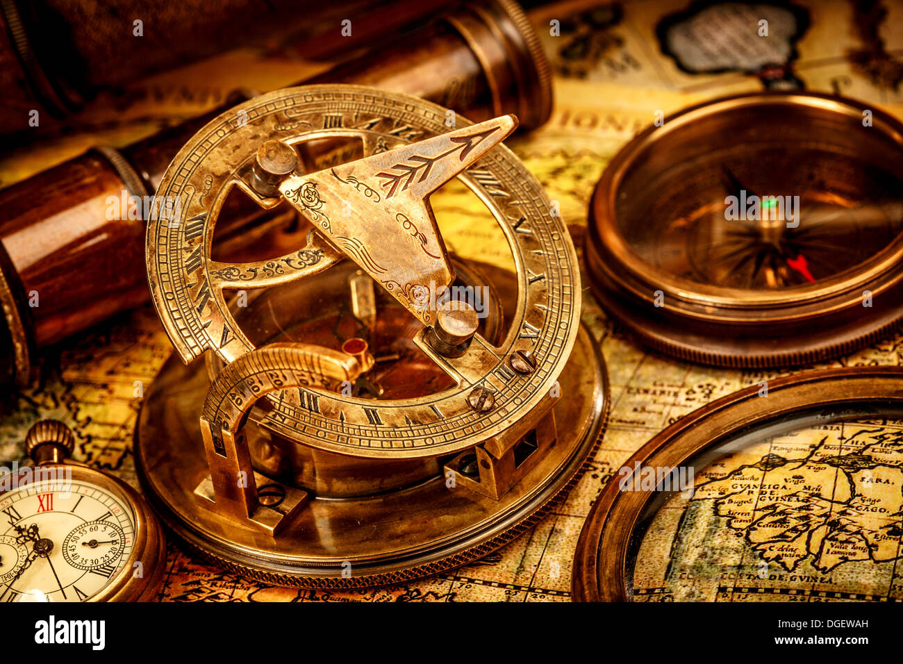 Vintage magnifying glass, compass, telescope and a pocket watch lying ...