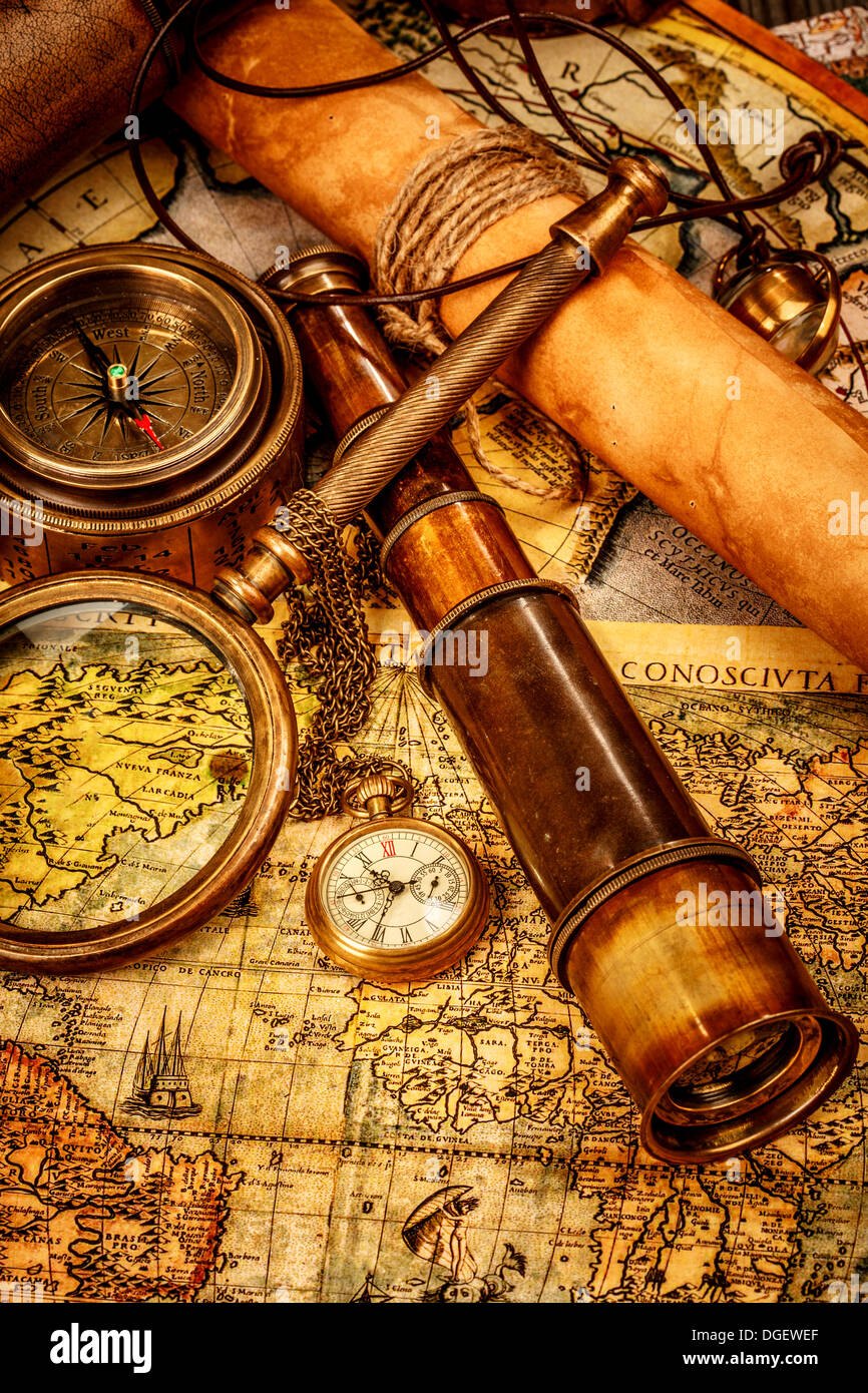 Vintage magnifying glass, compass, telescope and a pocket watch lying ...