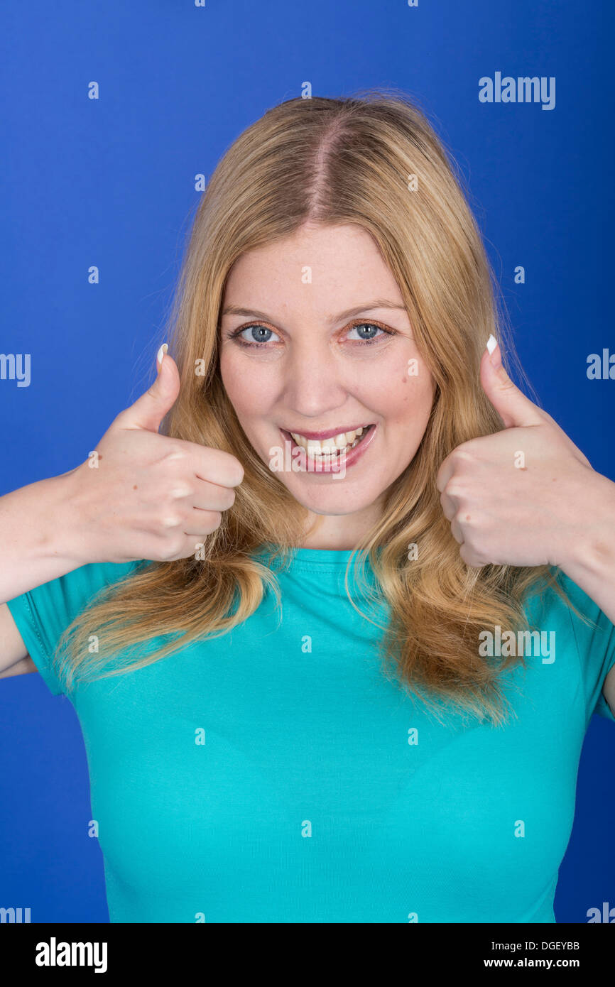 Model Released. Attractive Happy Young Woman Thumbs Up Stock Photo - Alamy