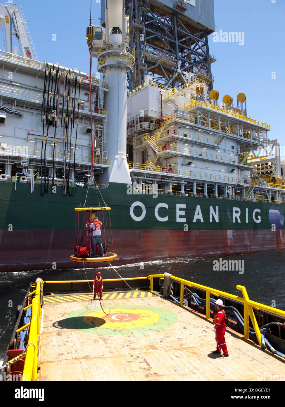 crew members of oil rig been transported on a basket to a supply ...