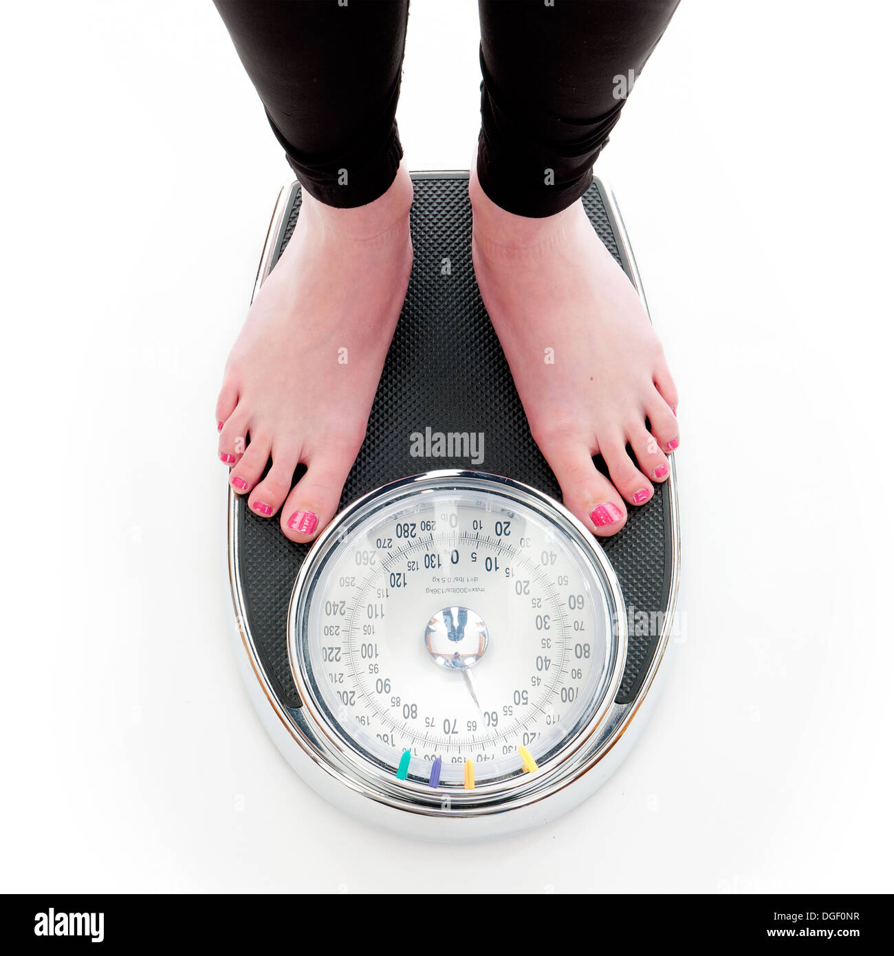 a girl on a weighing scale, on a white background Stock Photo - Alamy