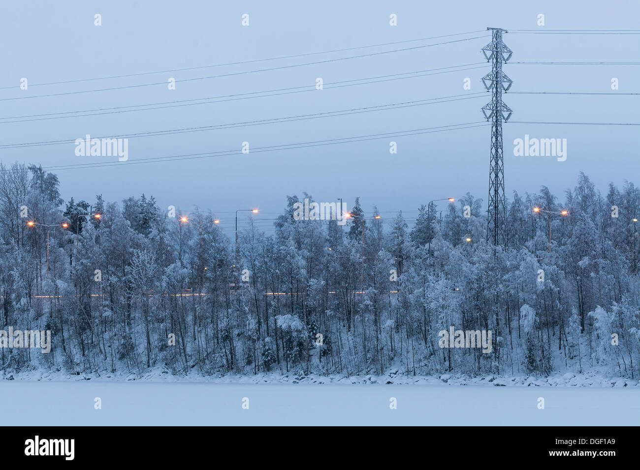 Powerlines and snowy trees in a wintry landscape in Tampere, Finland ...