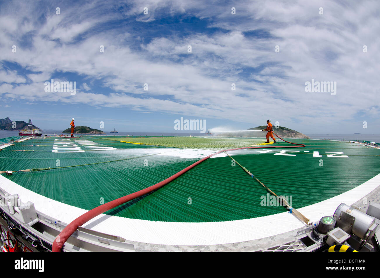 Oil rig crew members checking the foam cannons at the helicopter ...