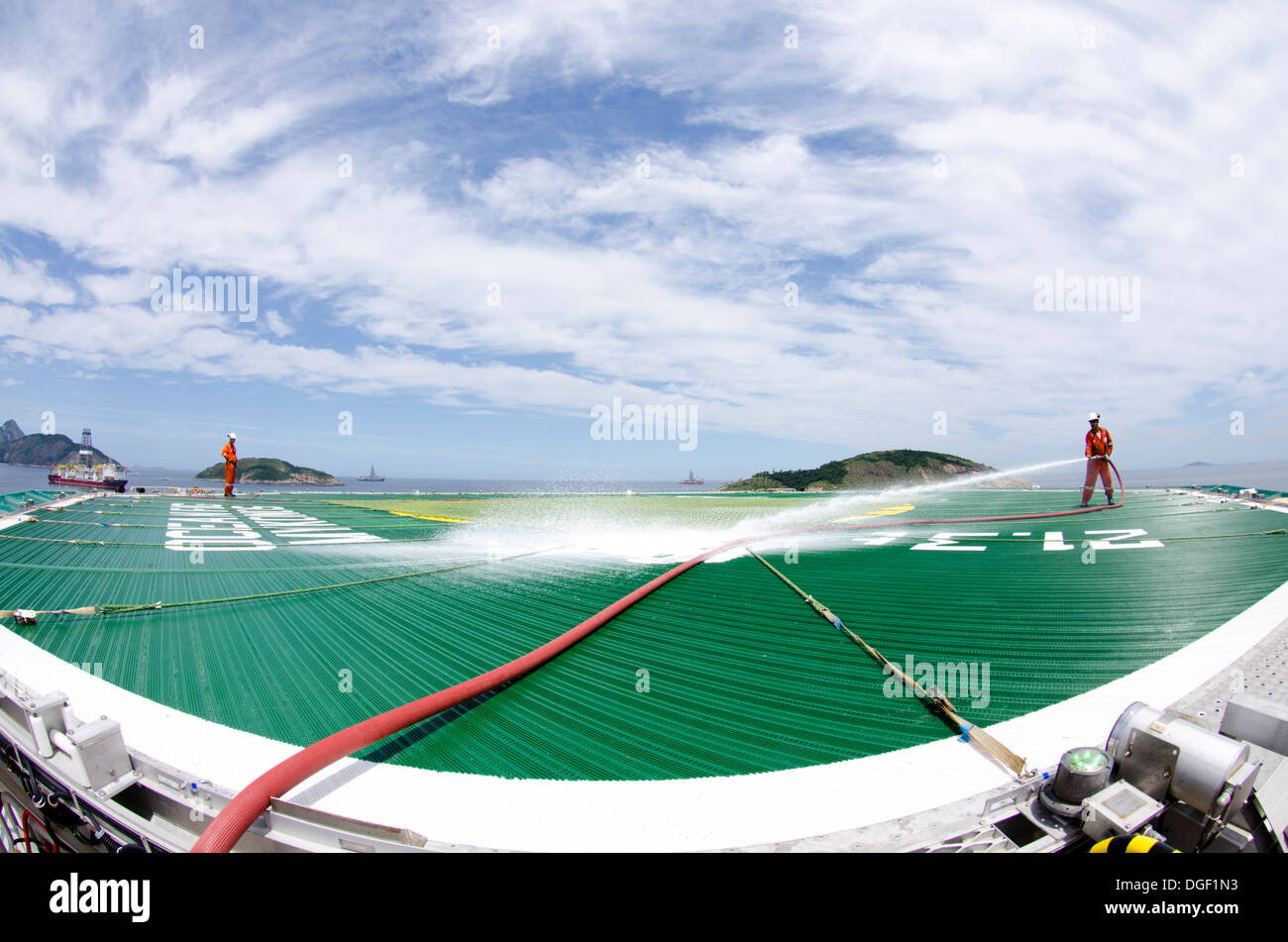 Oil rig crew members checking the foam cannons at the helicopter ...