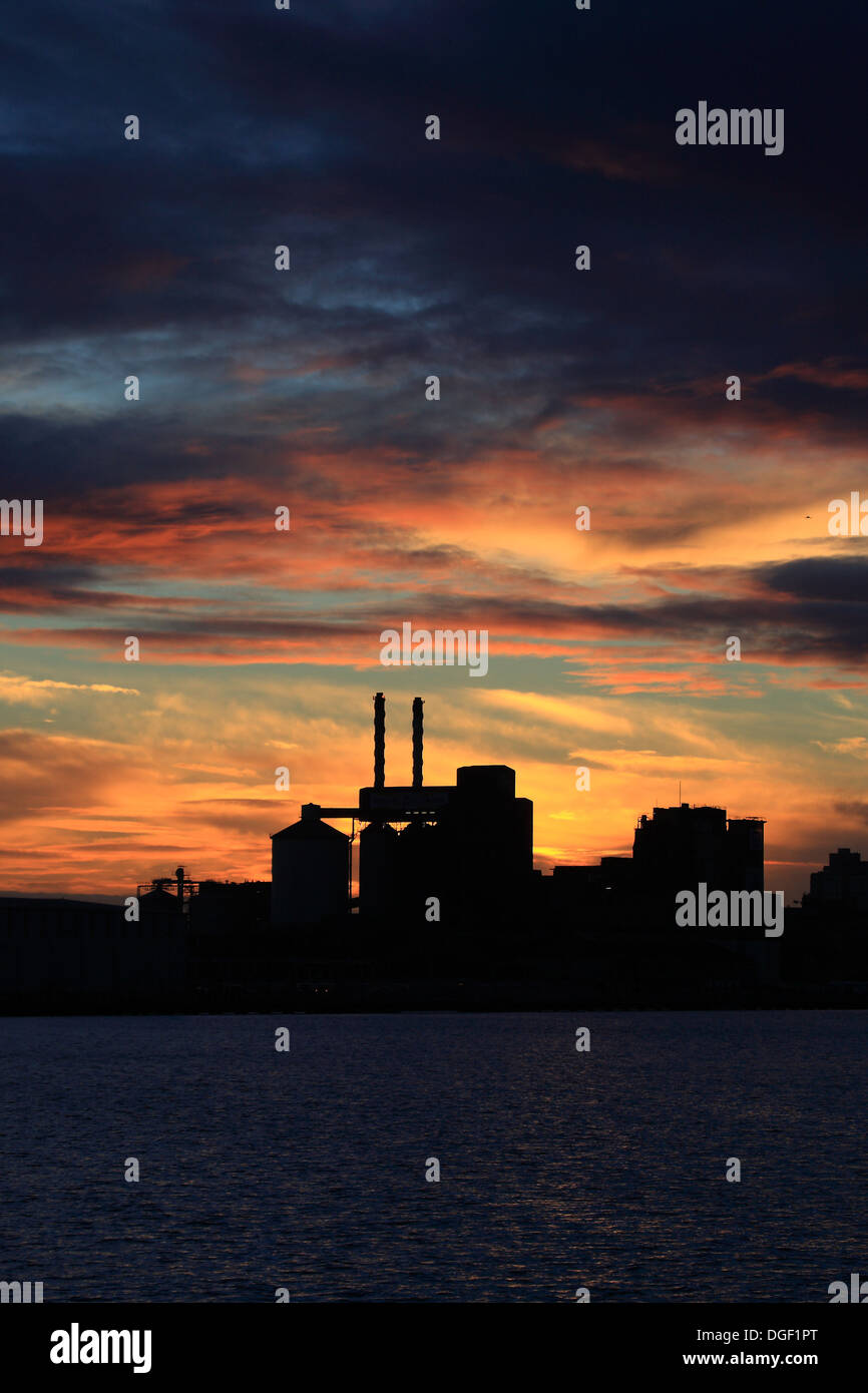 Sunset over East London as Tate and Lyle complex is silhouetted Stock ...