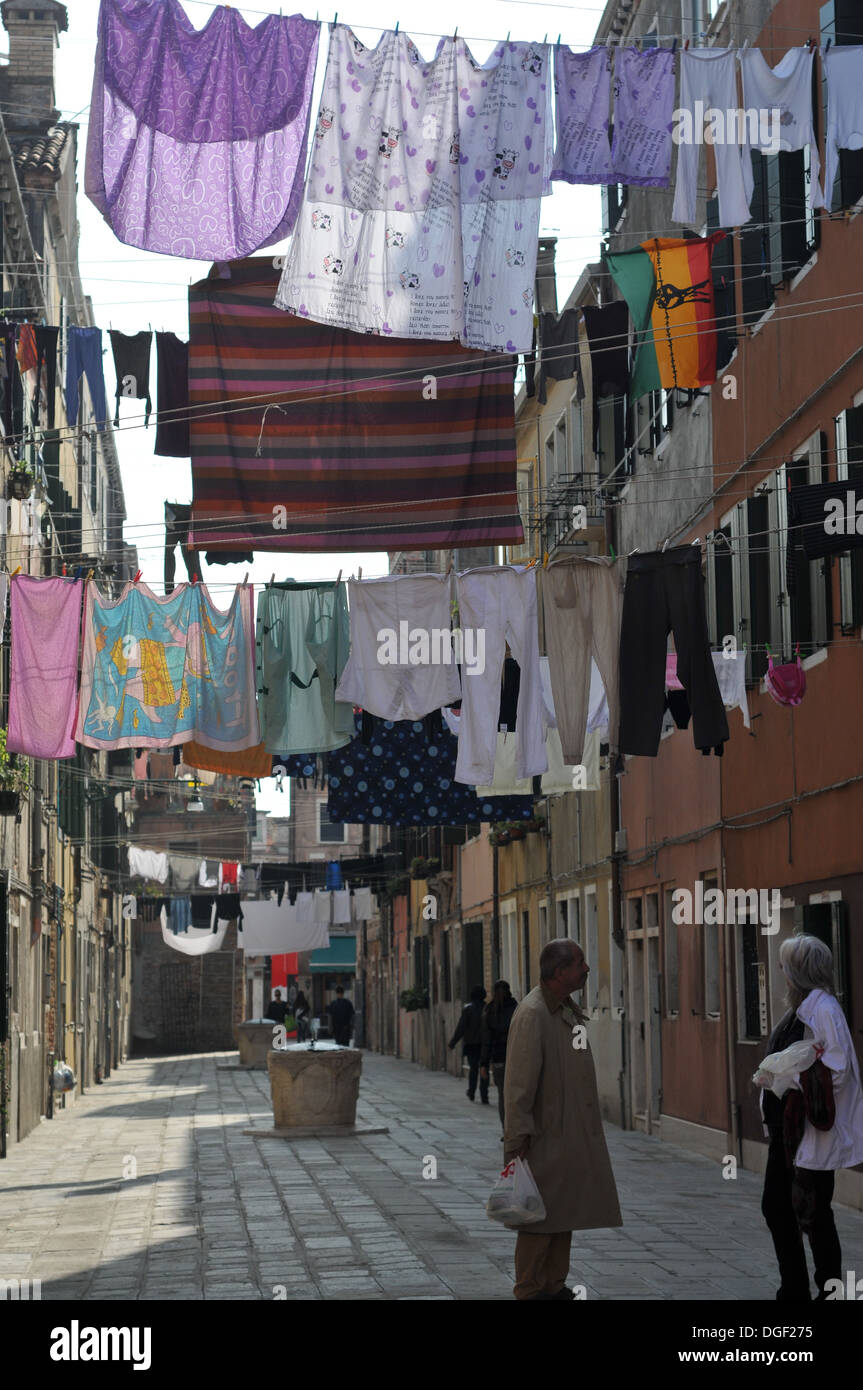 Clothes hanging from line between houses on the island Giudecca, Venice ...