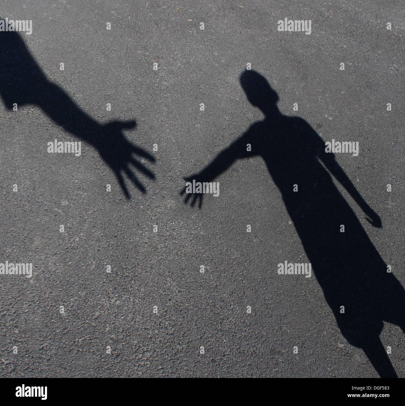 Helping Hand with a shadow on pavement of an adult hand offering help ...
