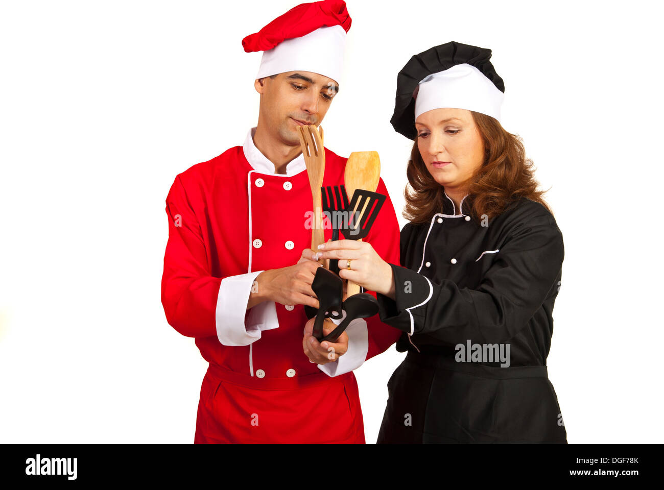 Chef giving each other kitchen utensils isolated on white background ...