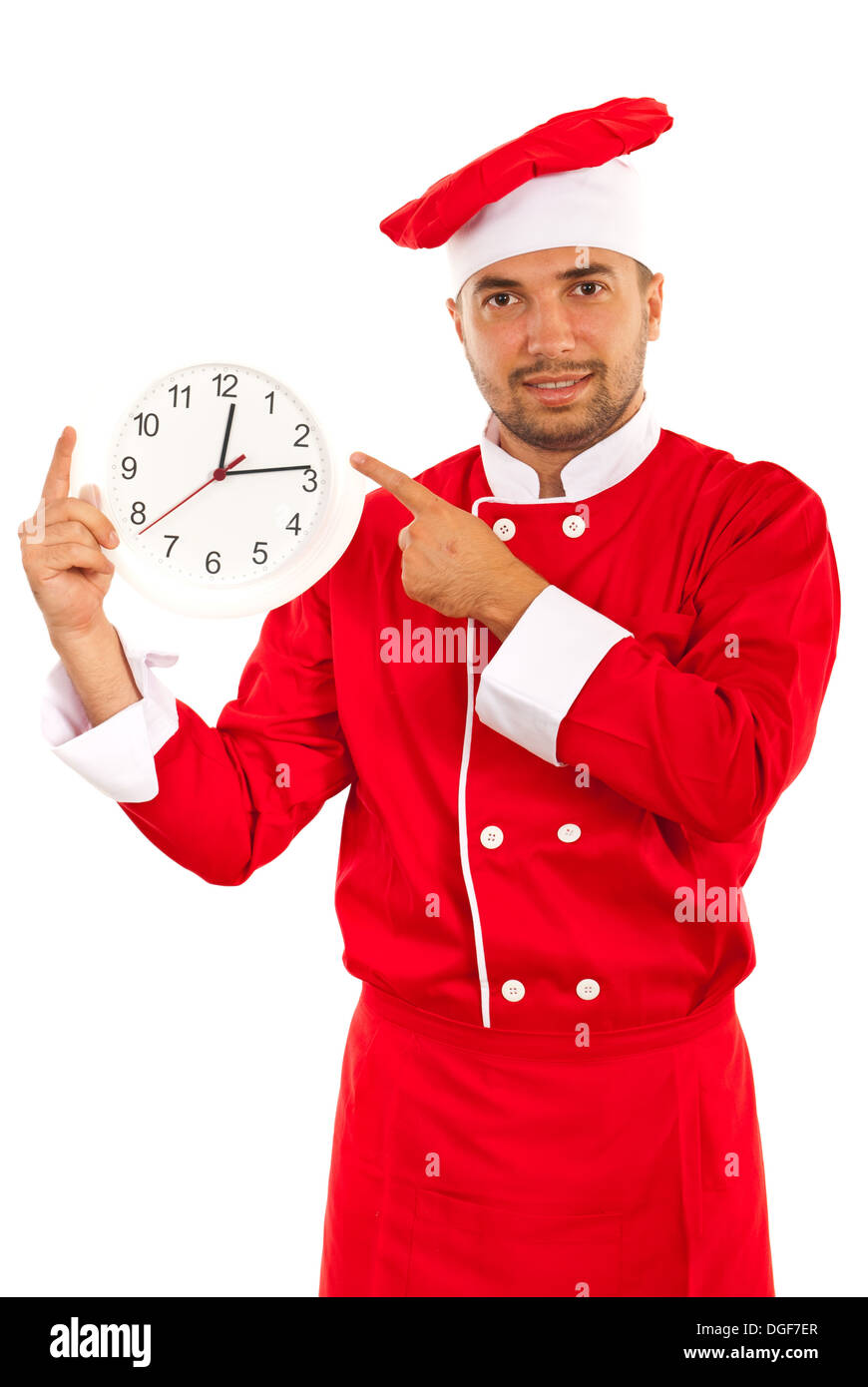Cheerful chef in red uniform pointing to clock isolated on white ...