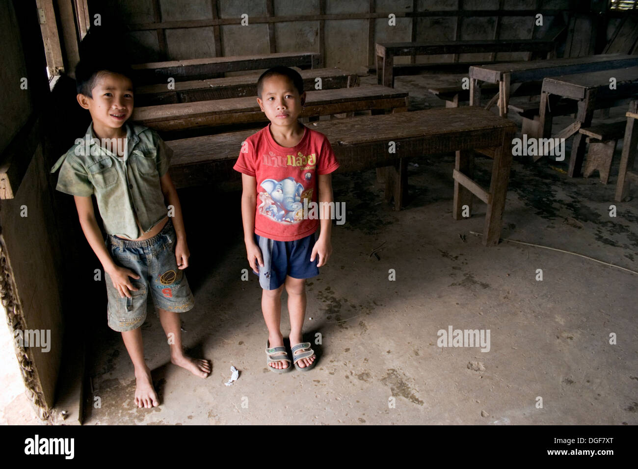 Two boys are standing near the door of their sparse classroom at a ...