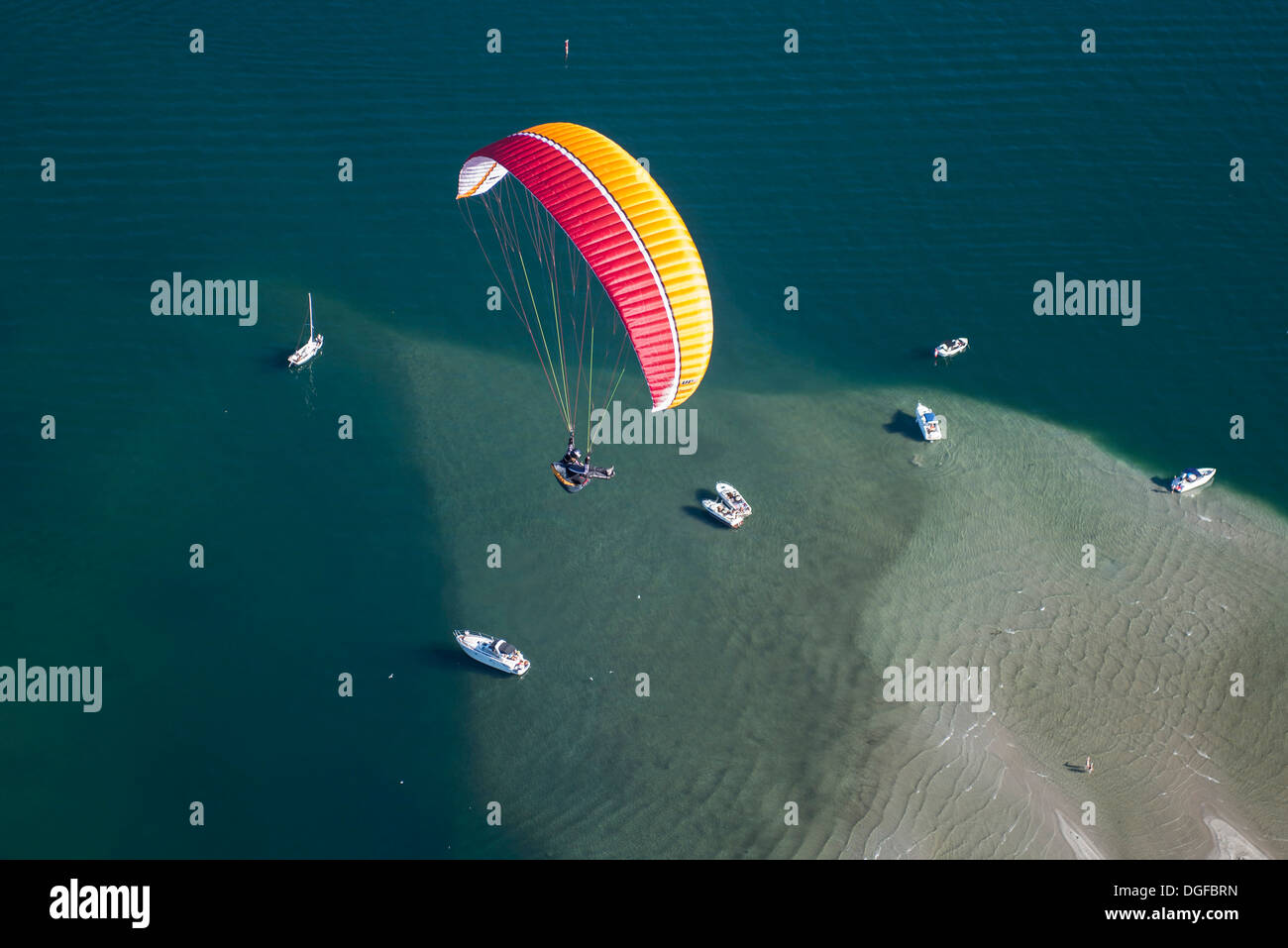 Paraglider over the Maggia river delta with naturally formed water and ...