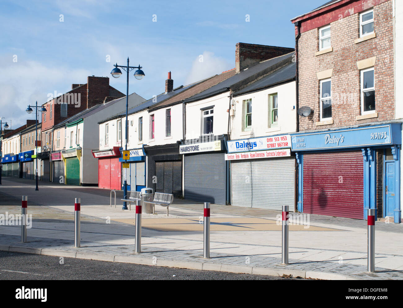 Row of deserted shuttered shops on a Sunday. Seaham, north east England ...