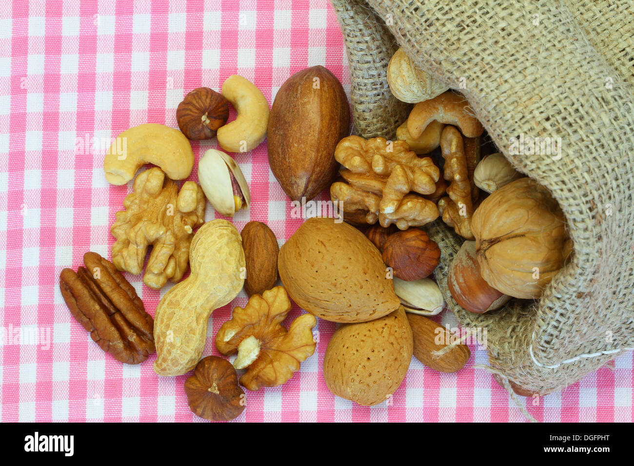 Selection of nuts in jute bag on pink checkered cloth Stock Photo - Alamy