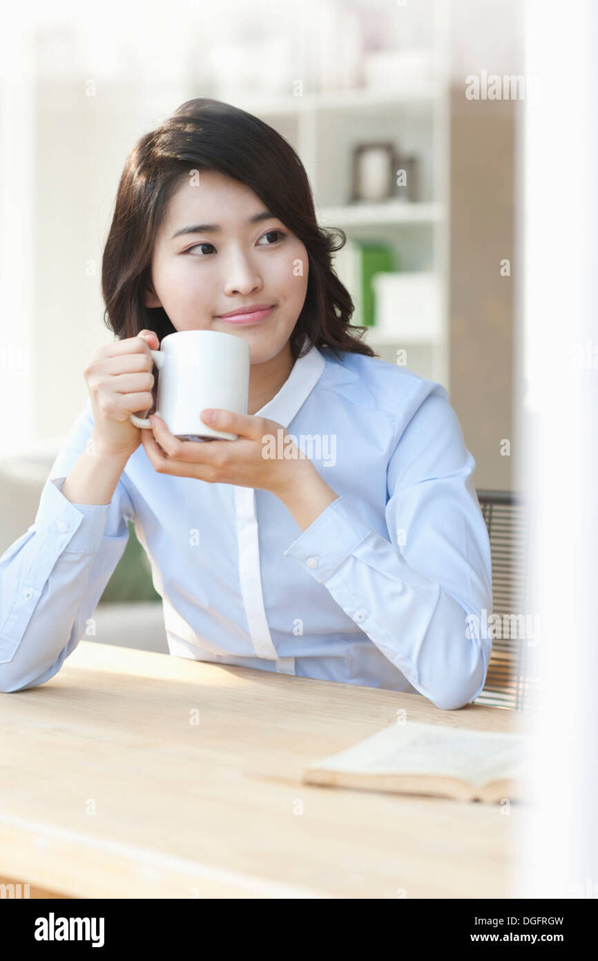 Woman laughing holding mug coffee hi-res stock photography and images ...