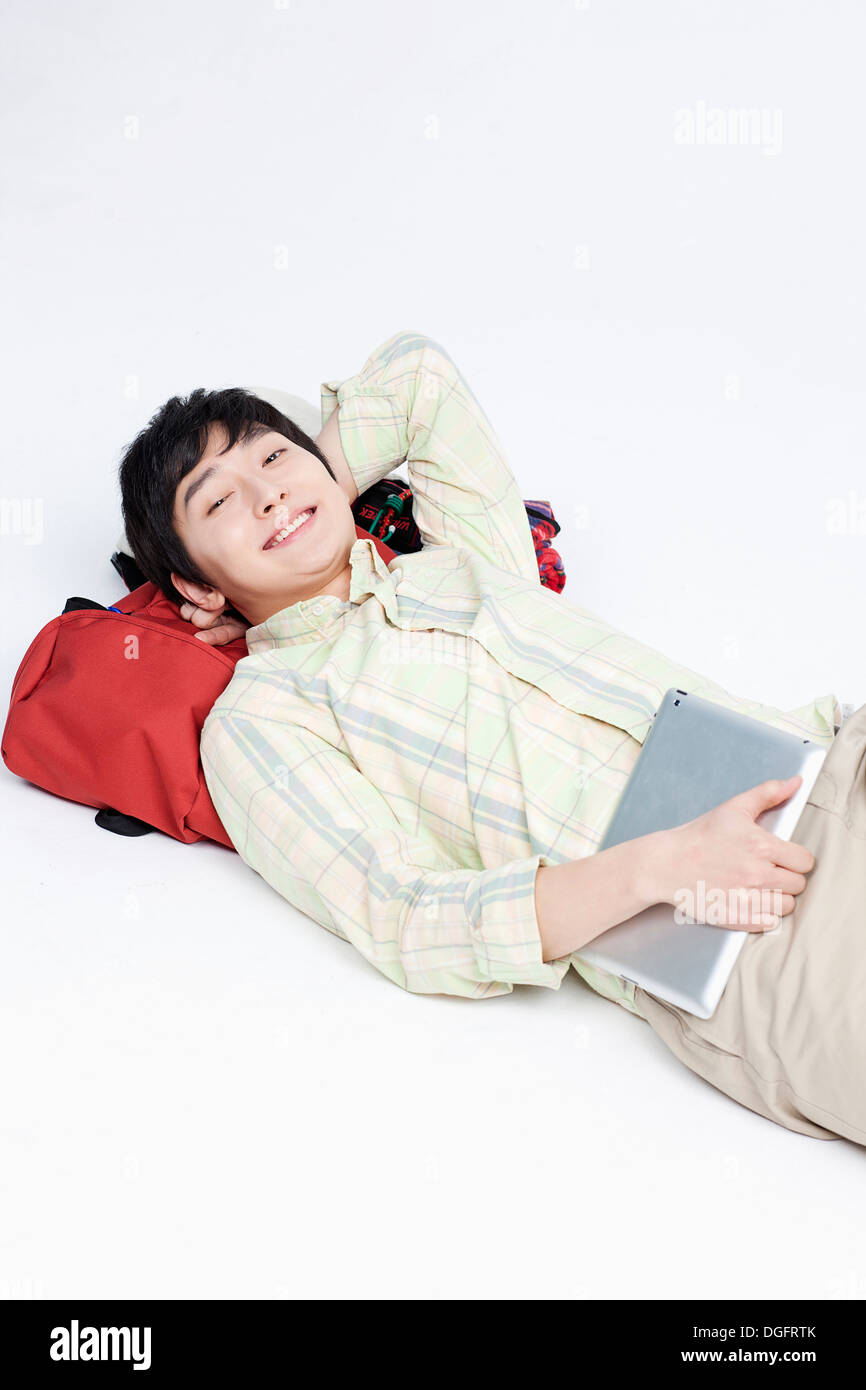 a boy lying on hiking back pack Stock Photo - Alamy