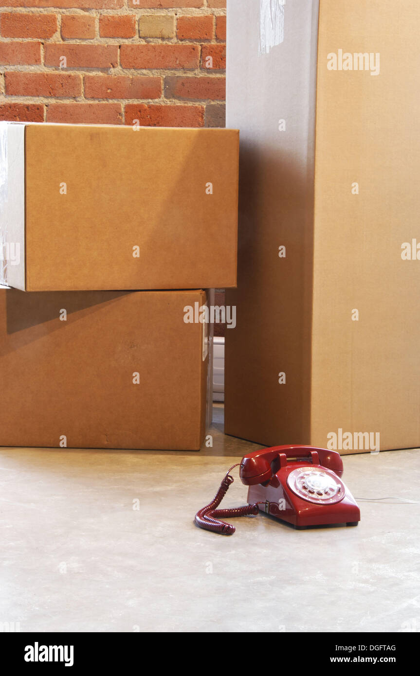 red telephone on floor with moving boxes in background Stock Photo - Alamy