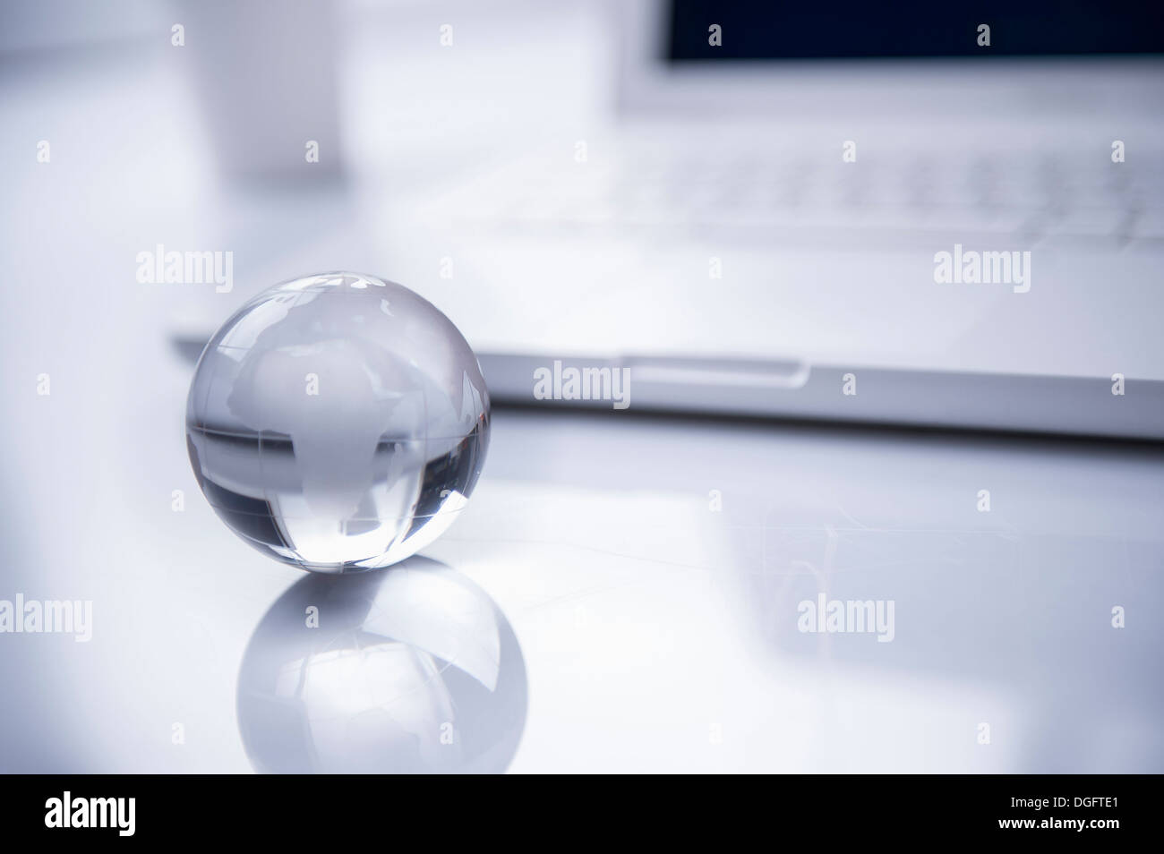 a glass ball on a working desk Stock Photo - Alamy