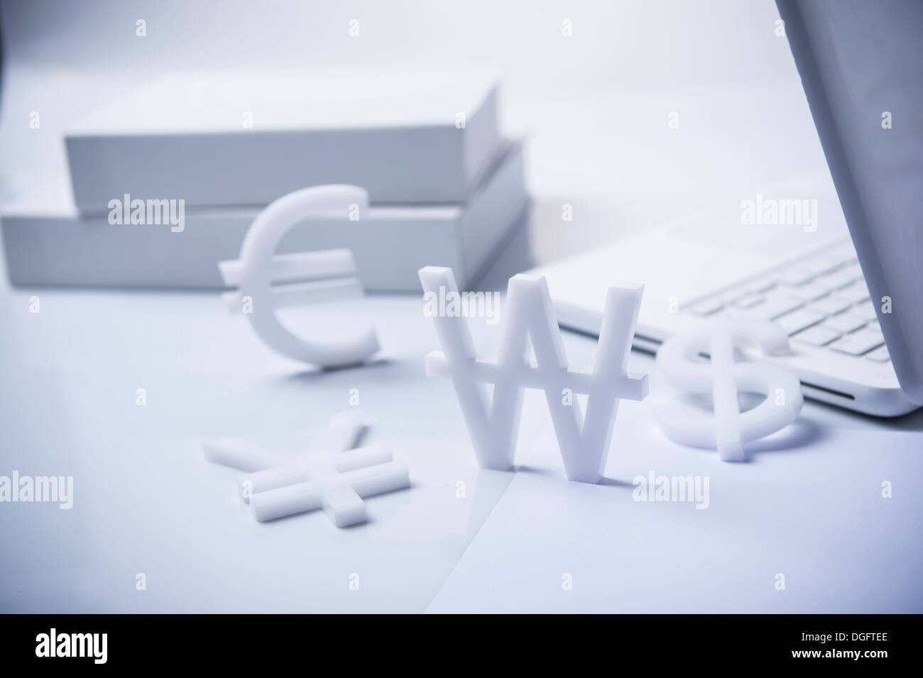 a working desk with a currency icons and a laptop Stock Photo - Alamy