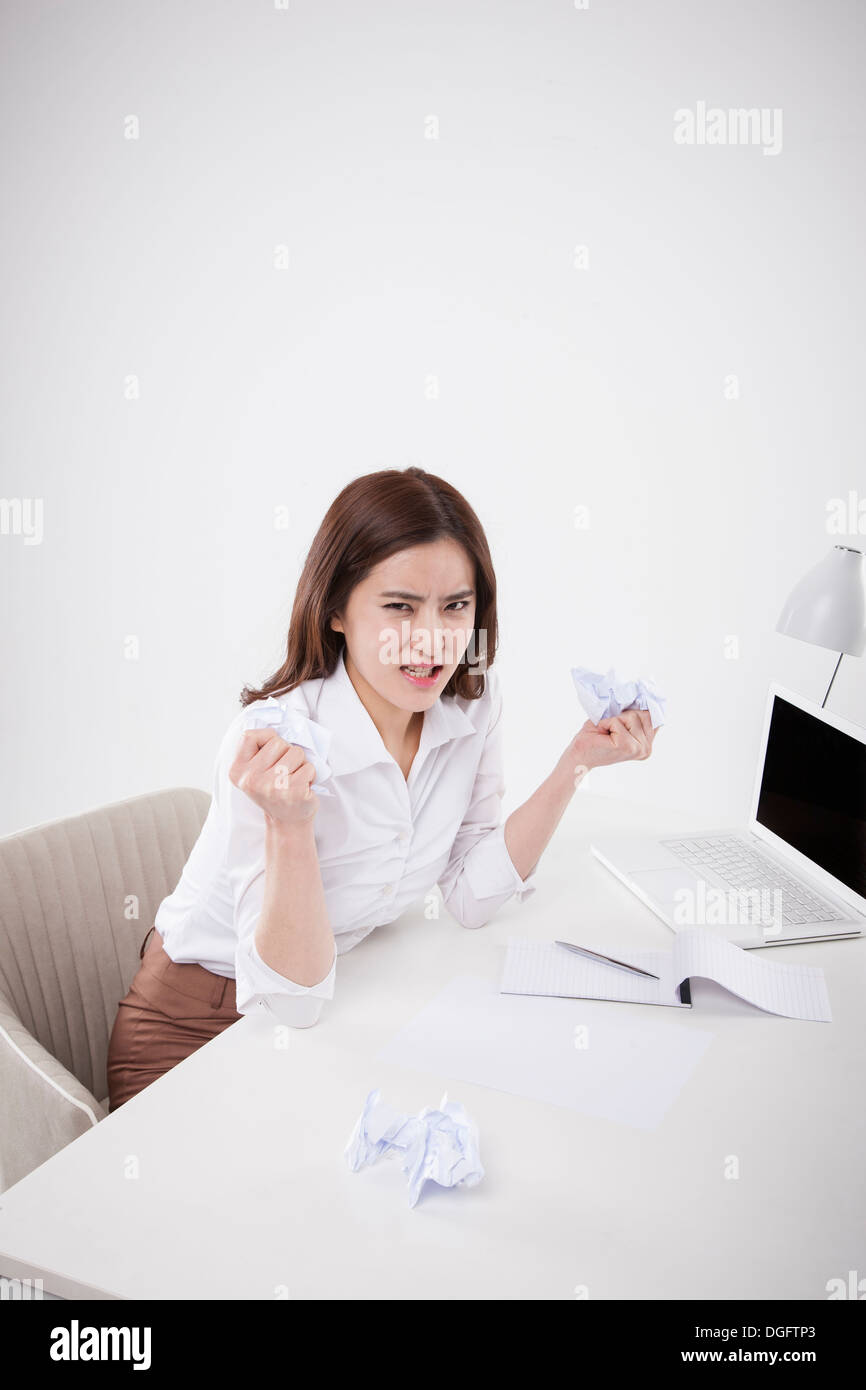 a business woman annoyed at desk Stock Photo - Alamy