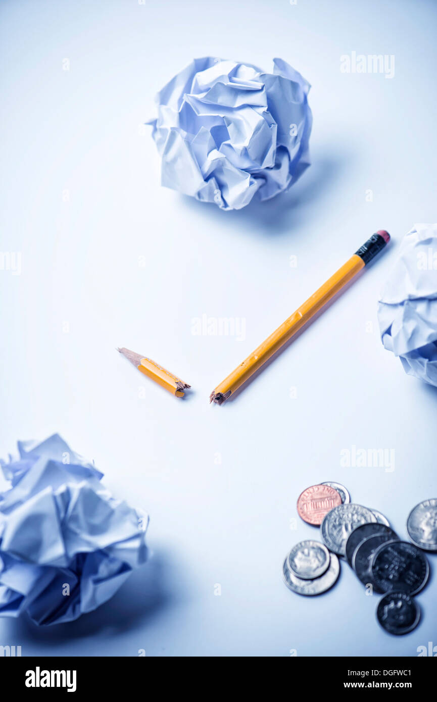 coins, a broken pencil and paper balls Stock Photo - Alamy