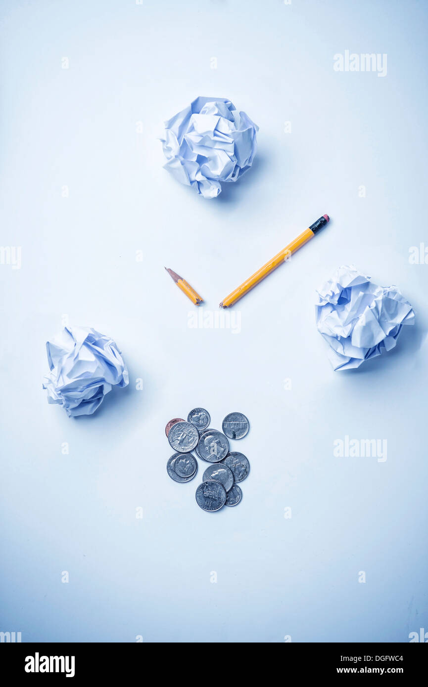 coins, a broken pencil and paper balls Stock Photo - Alamy