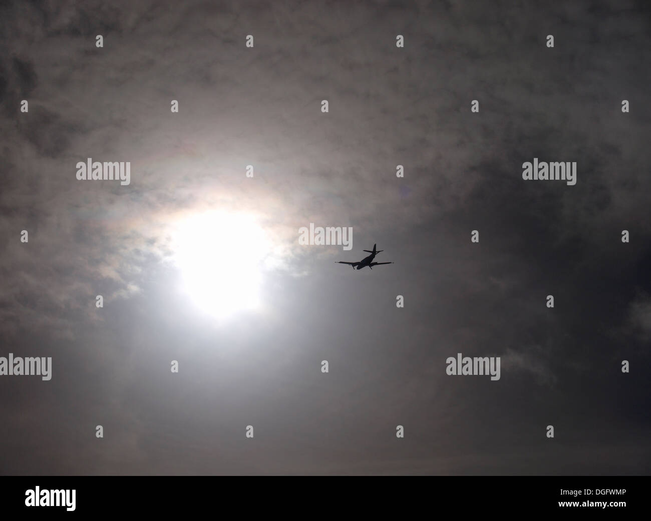 Aeroplane flying into the sun, UK Stock Photo - Alamy