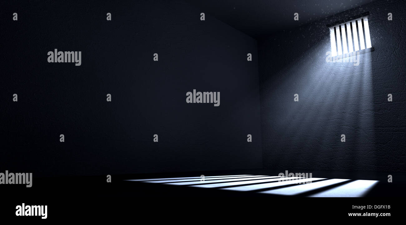 An old jail cell interior with barred up window with light rays penetrating through it ...