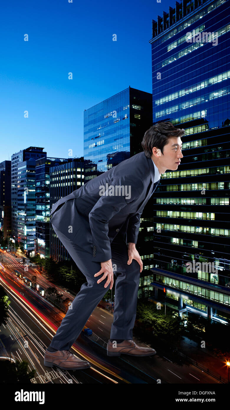a business man looking into a building Stock Photo - Alamy