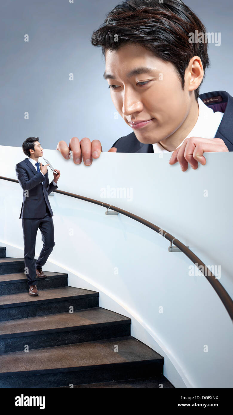 Giant man looking at small man hi-res stock photography and images - Alamy