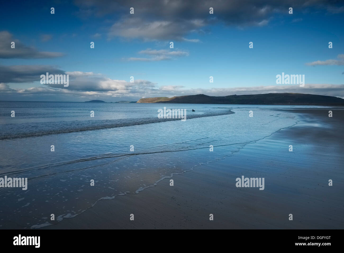 curves wavelets calm cold blue sky sea beach Stock Photo - Alamy