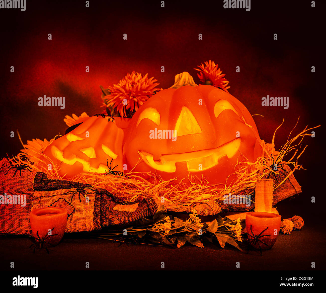 Scary Halloween still life on dark red background, creepy carved ...