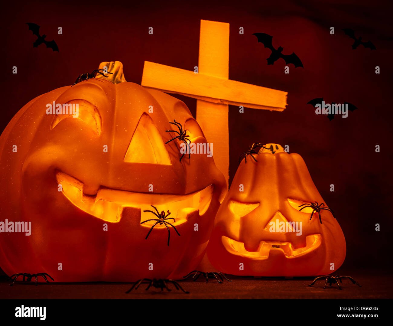 Halloween on cemetery, glowing scary gourd and creepy cross, flying ...