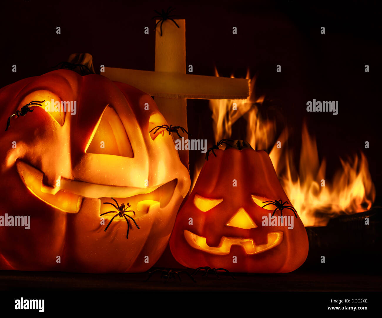 Scary Halloween night, aggressive burning fire on cemetery near cross ...