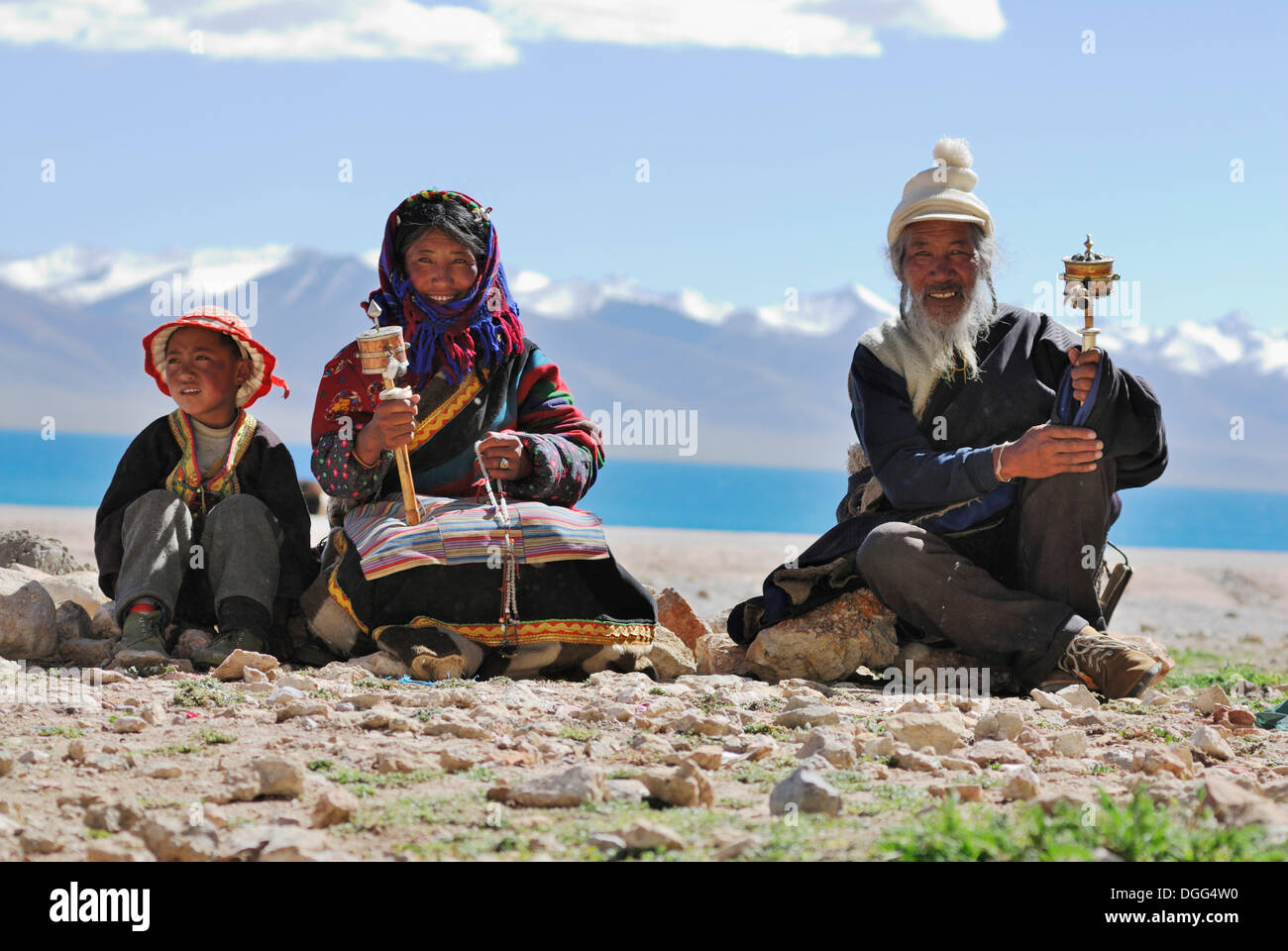 Tibetan pilgrims with prayer wheels at Namtso Lake, Heavenly Lake ...