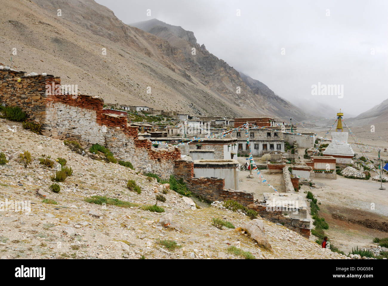 Rongbuk monastery and white stupa in front of the cloudy Mt. Everest ...