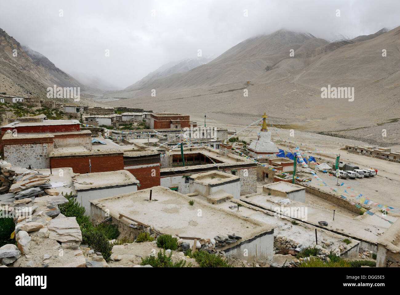 Rongbuk monastery and white stupa in front of the cloudy Mt. Everest ...