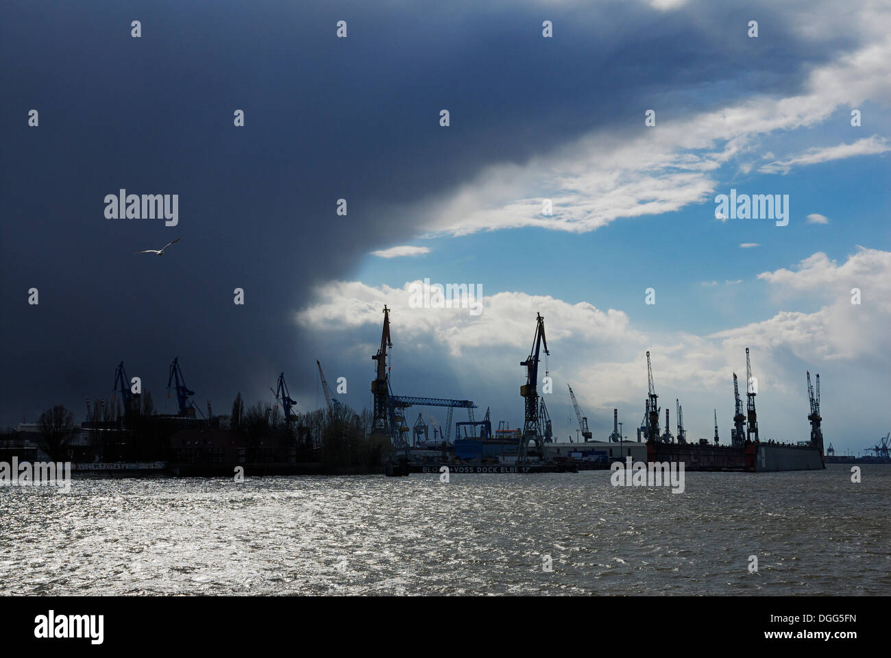 Stormy atmosphere, docks of Blohm & Voss shipyard in the port, as seen ...