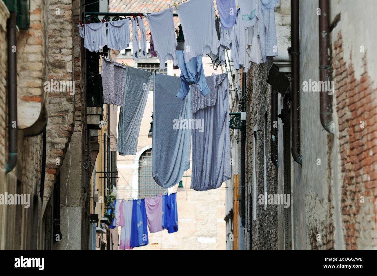 Closely built houses, washing hanging on washing lines stretched over a ...