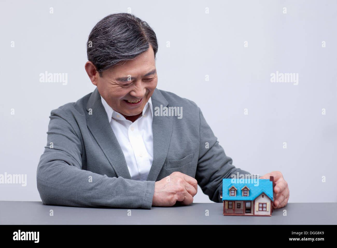 an old man with a miniature house Stock Photo - Alamy