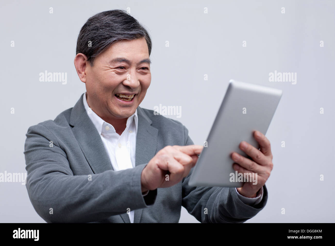 an old man holding a tablet Stock Photo - Alamy