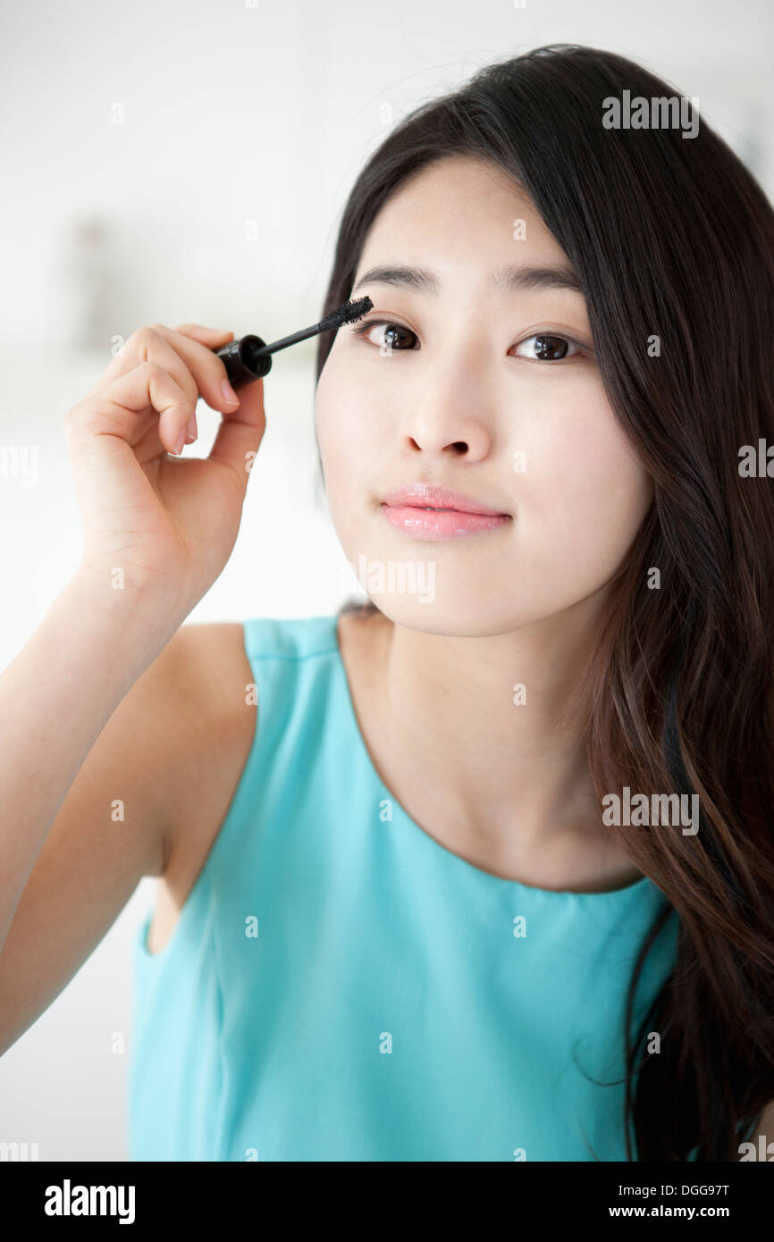 a young woman putting make up on Stock Photo - Alamy