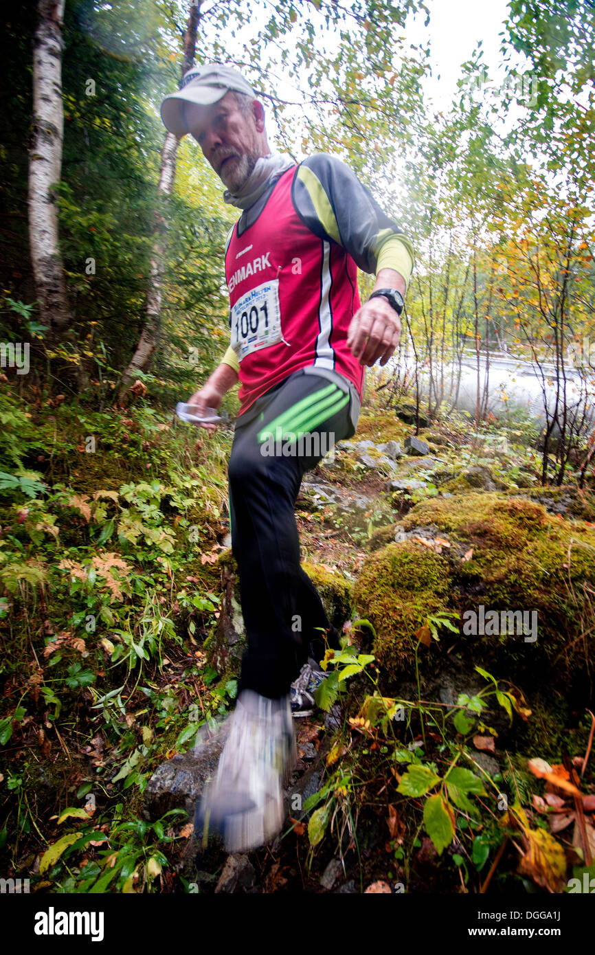 A runner going down a steep and slippery path during a trailrun Stock ...