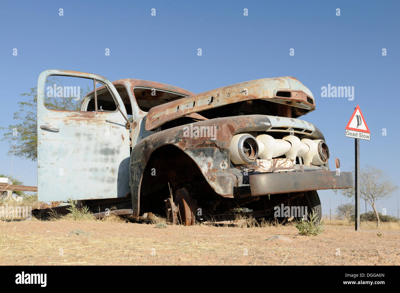 Road sign, Dead Slow, alongside a wrecked car, vintage car, Solitaire ...