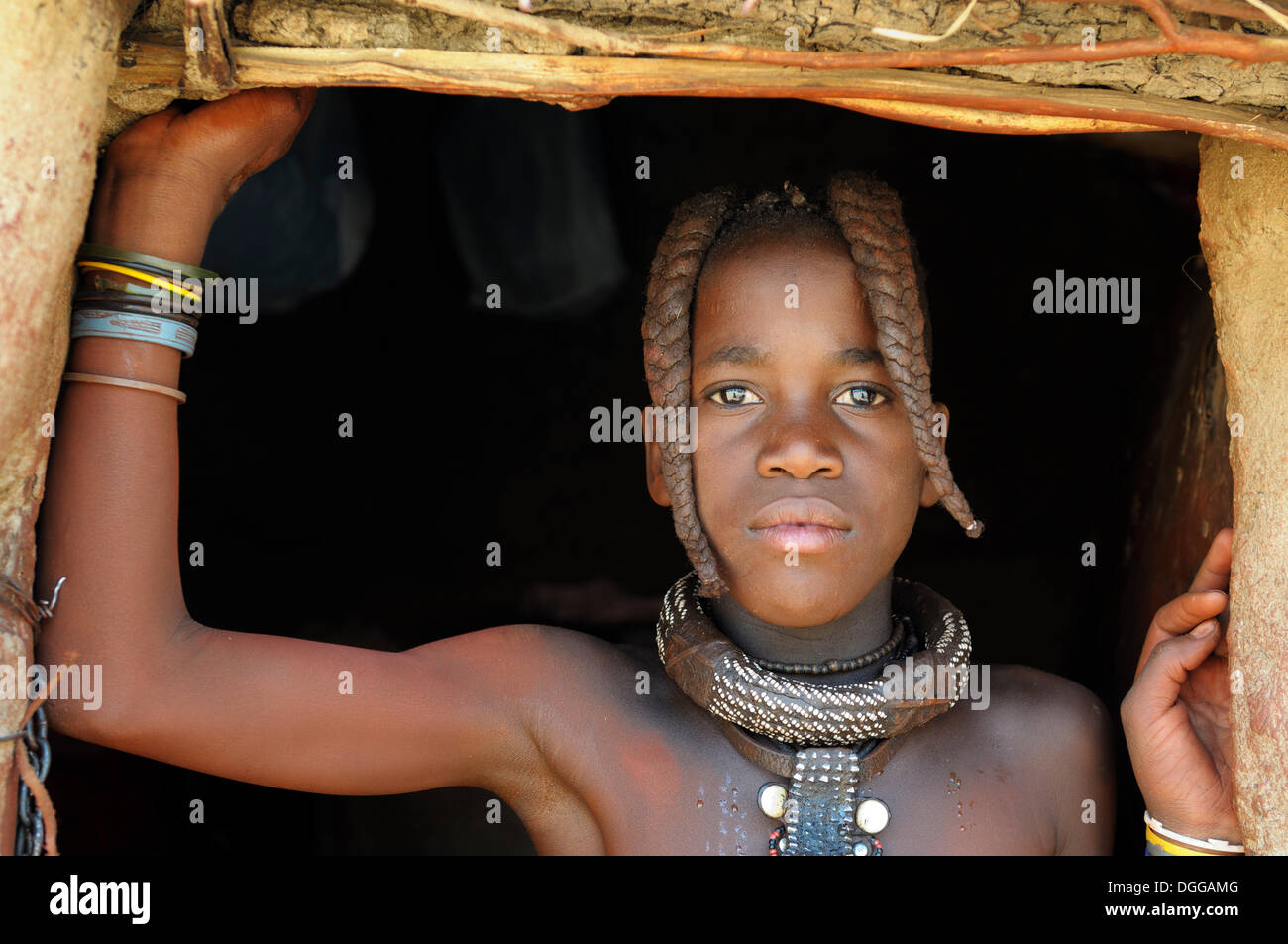 Himba girl with two braids and jewellery, portrait, Himba hut, Himba ...